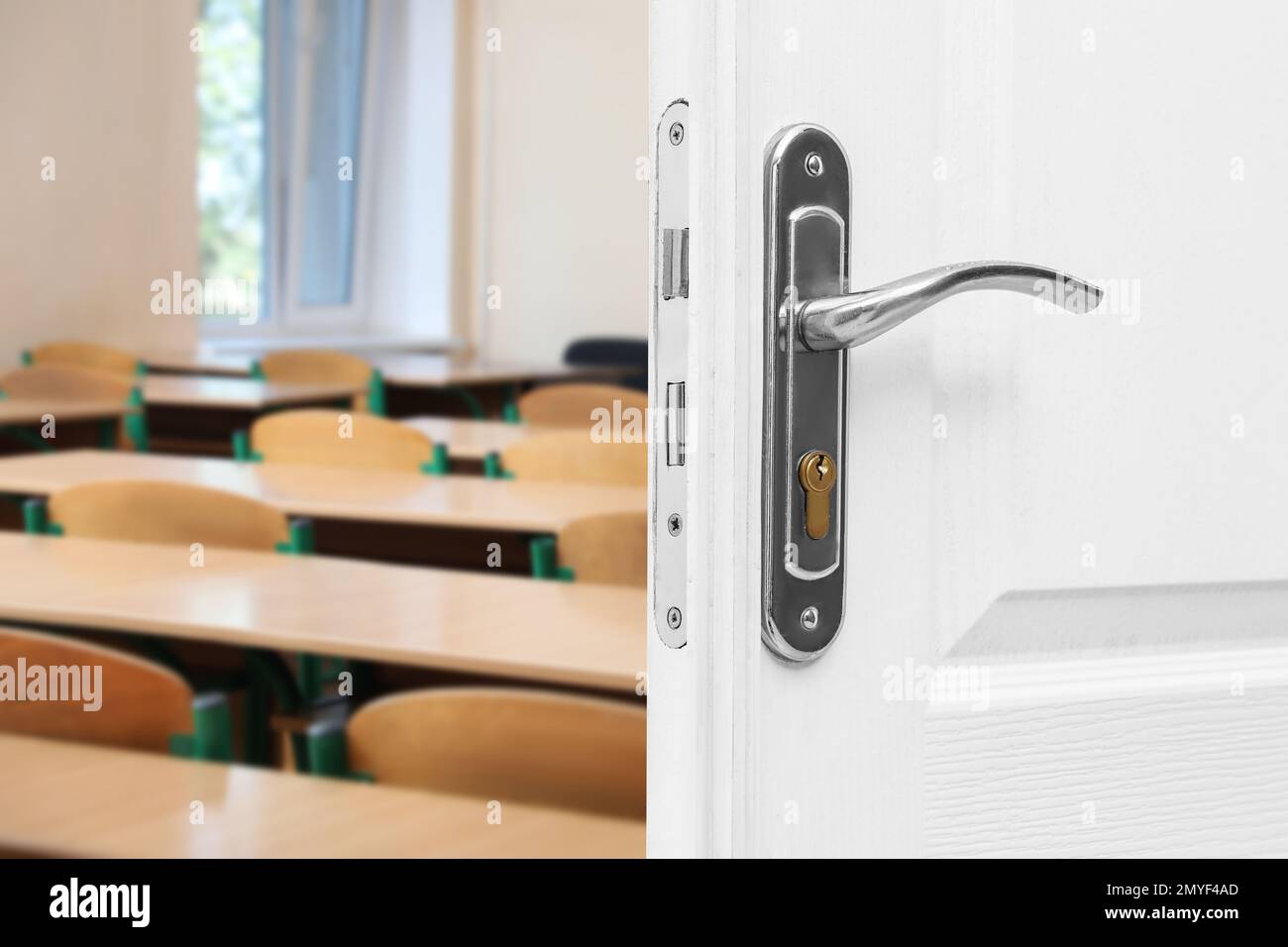 Wooden door open into modern empty classroom Stock Photo - Alamy