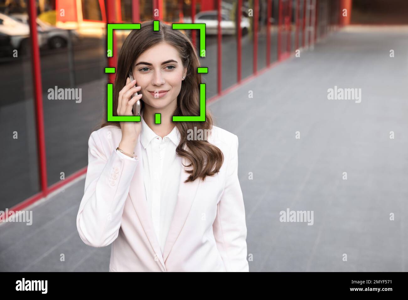 Facial recognition system identifying woman on city street Stock Photo ...
