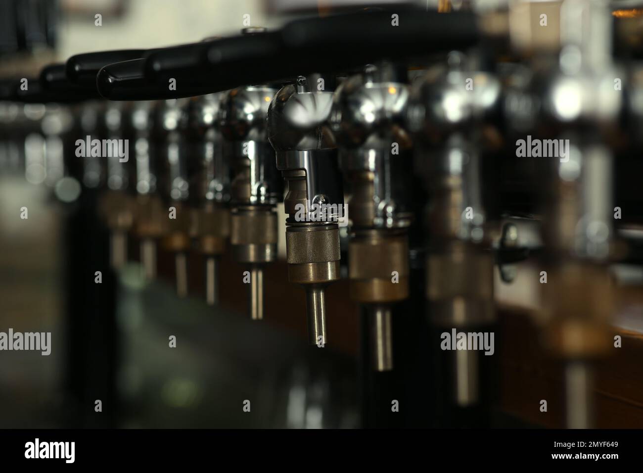 New modern beer taps in pub, closeup. Professional bar equipment Stock ...