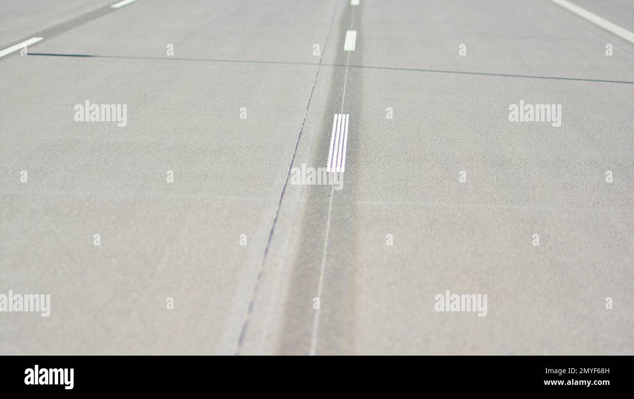 Straight modern concrete motorway with bright road marking ...