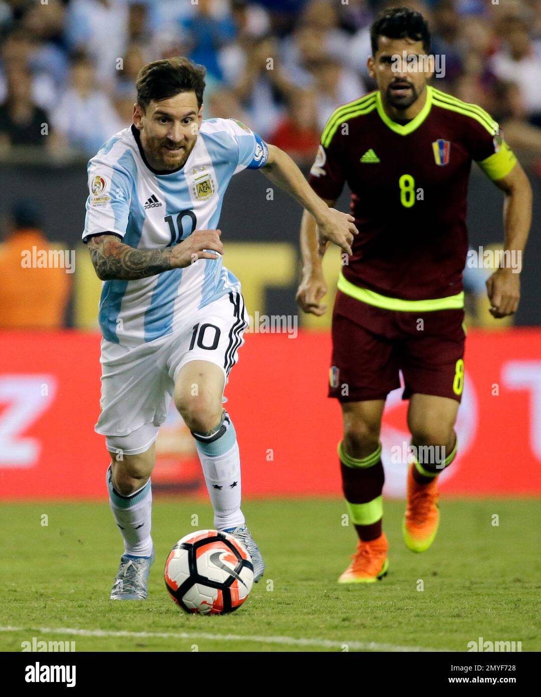 Argentina's Lionel Messi (10) moves the ball against Venezuela's Tomas ...