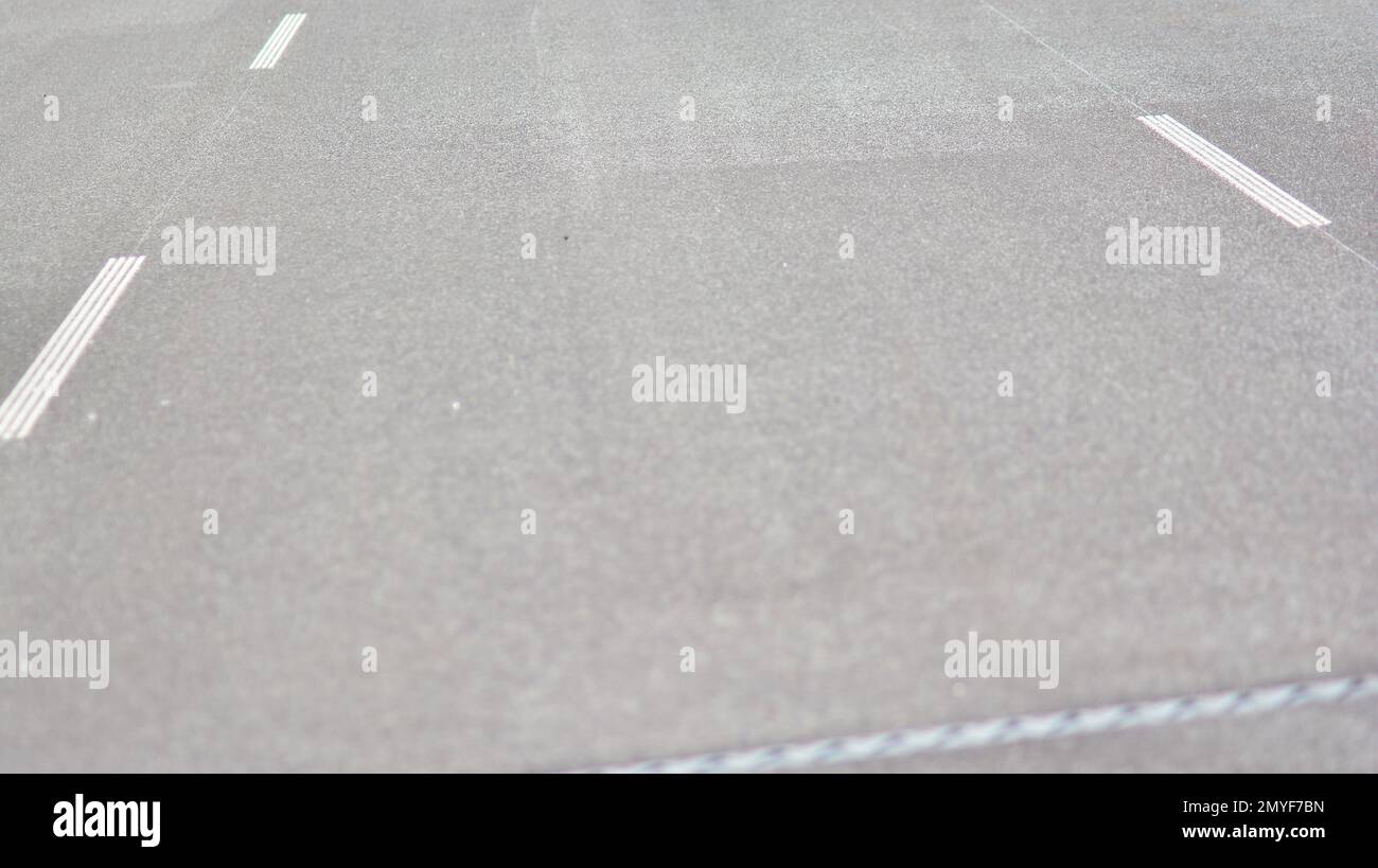 Straight modern concrete motorway with bright road marking ...