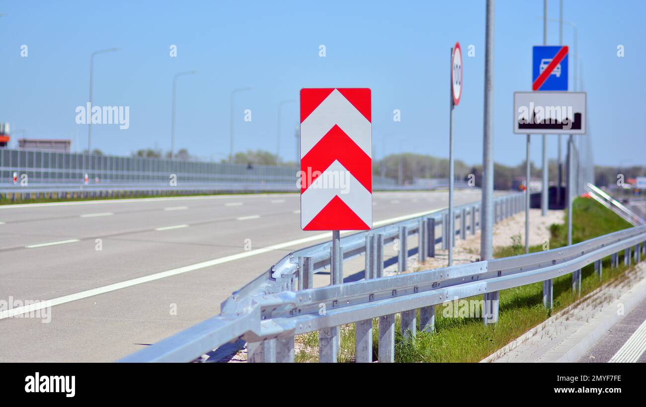 Straight modern concrete motorway with bright road marking ...