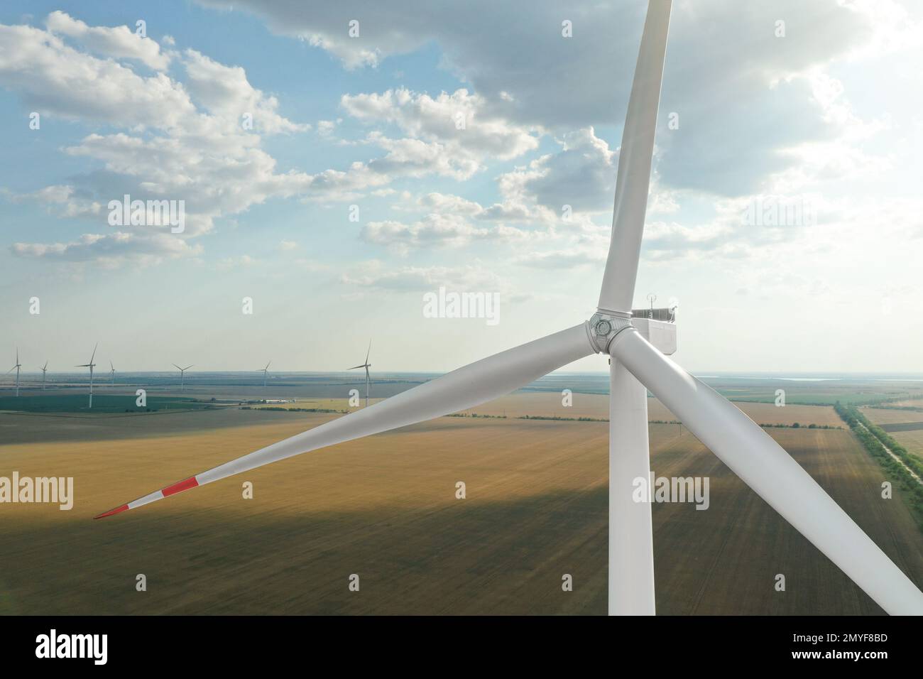 Modern windmill in wide field. Energy efficiency Stock Photo - Alamy