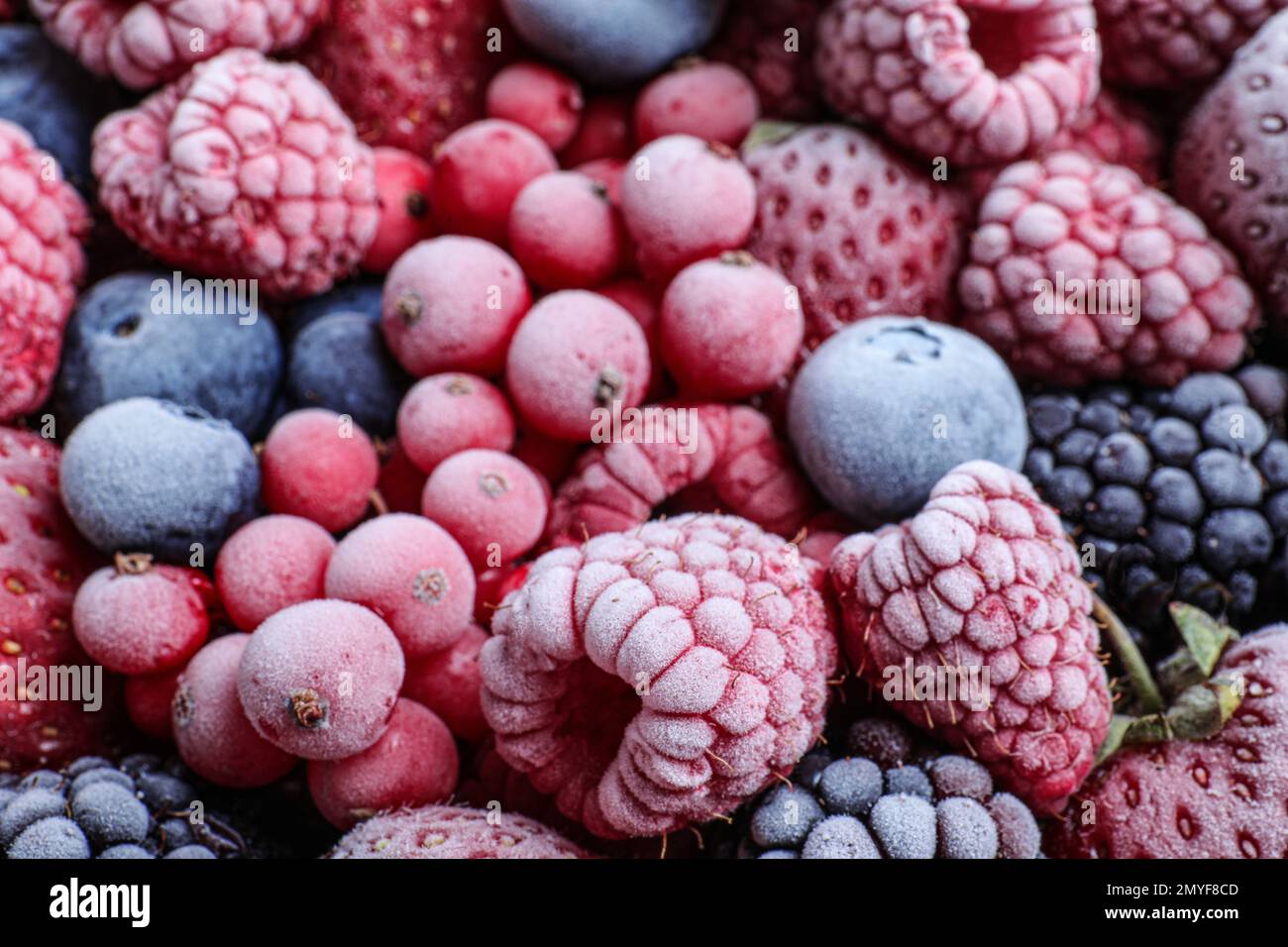 Mix of different frozen tasty berries as background, closeup Stock ...