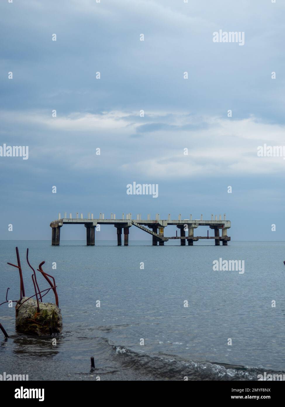Reinforced concrete sticking out of the water. Remains of an old bridge ...
