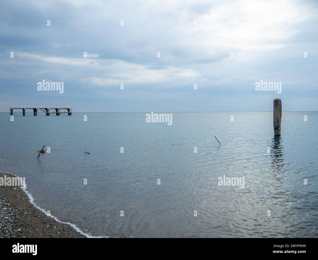 Reinforced concrete sticking out of the water. Remains of an old bridge ...