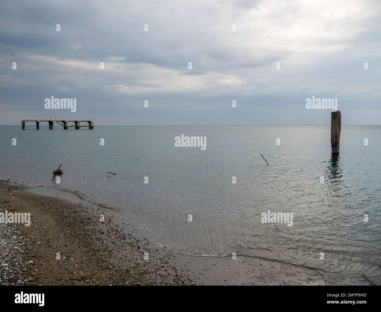 Reinforced concrete sticking out of the water. Remains of an old bridge ...