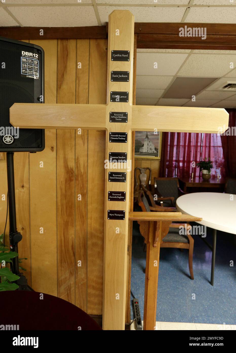 A cross with the names of the victims stands in the basement at Mother ...