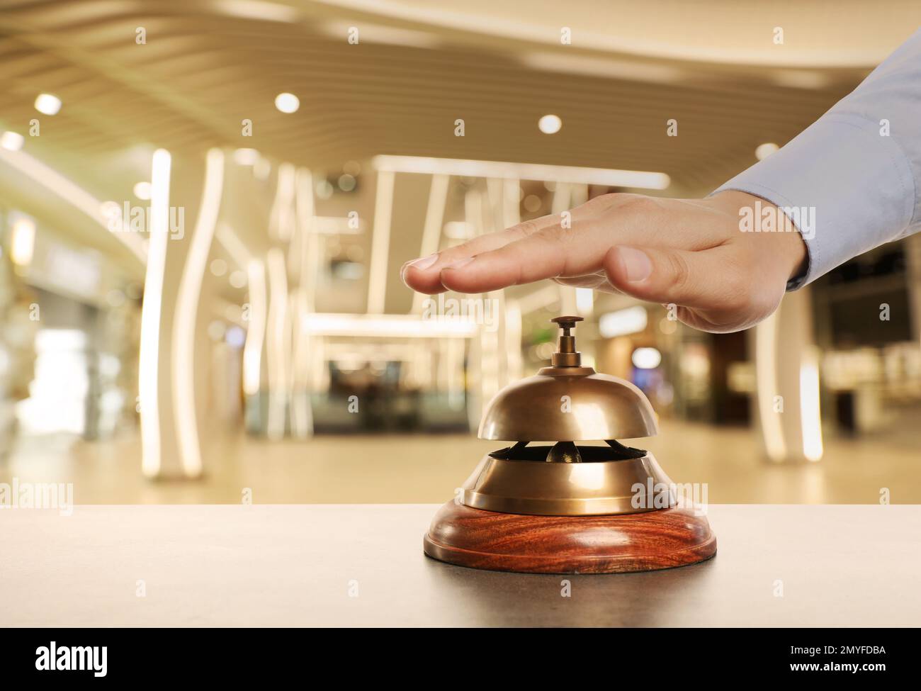 Man ringing hotel service bell on blurred background, closeup Stock ...