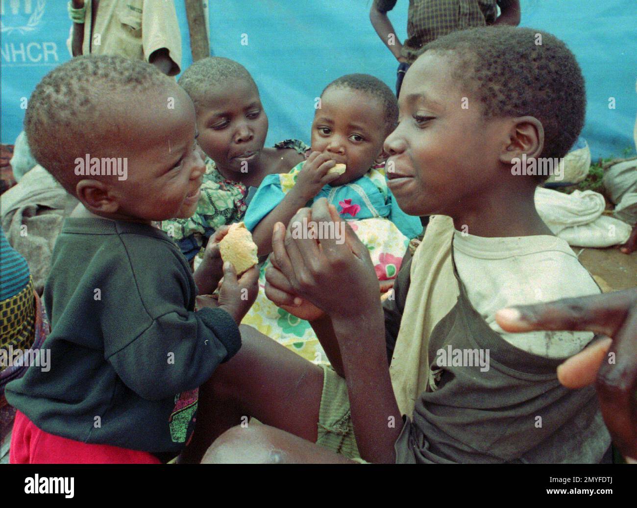 Hutu refugee children enjoy high protein biscuits at Ruyenzi transit ...