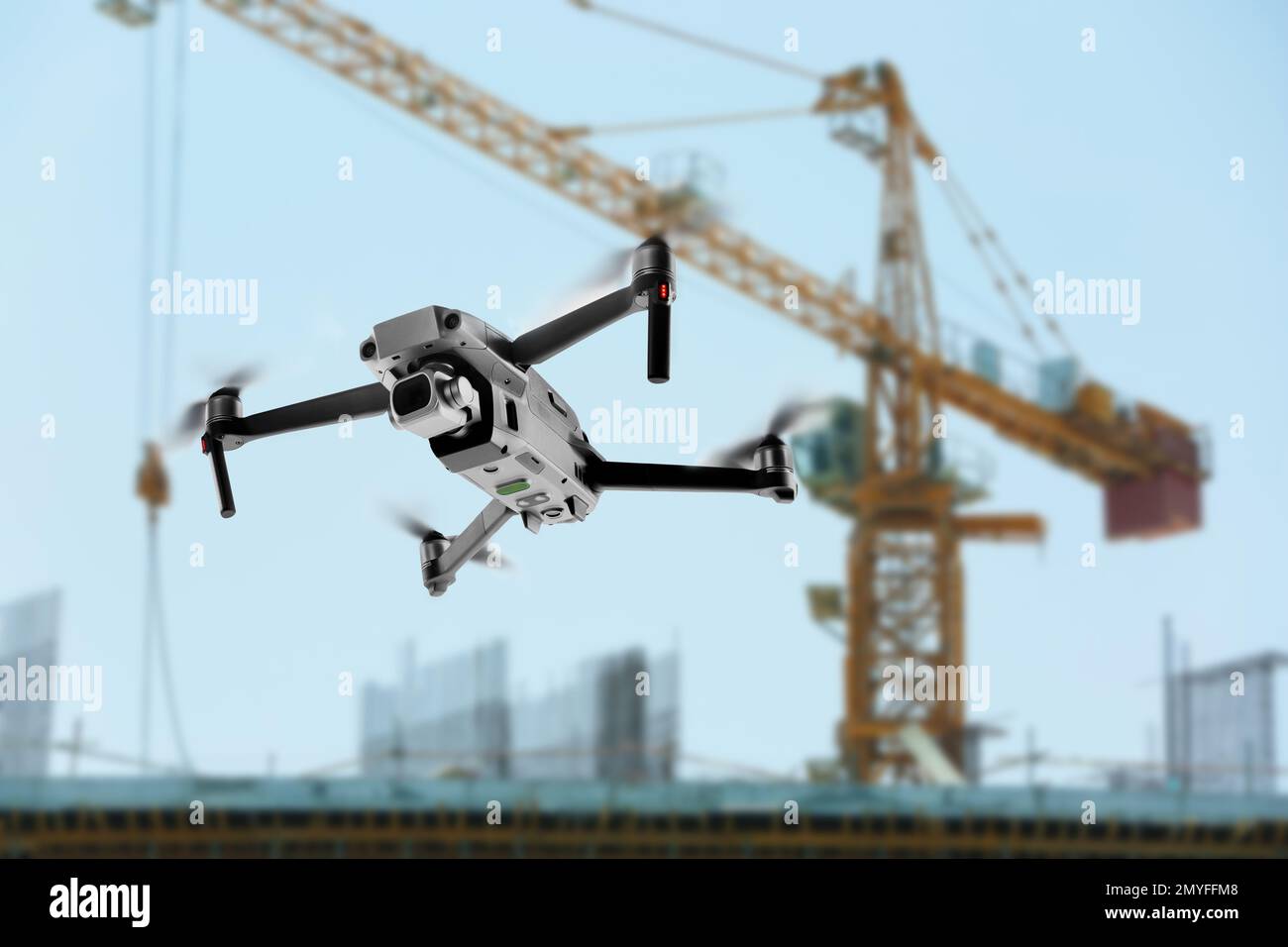Modern drone flying at building site. Aerial survey Stock Photo - Alamy
