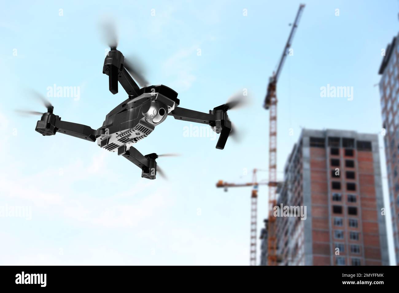 Modern drone flying at building site. Aerial survey Stock Photo - Alamy