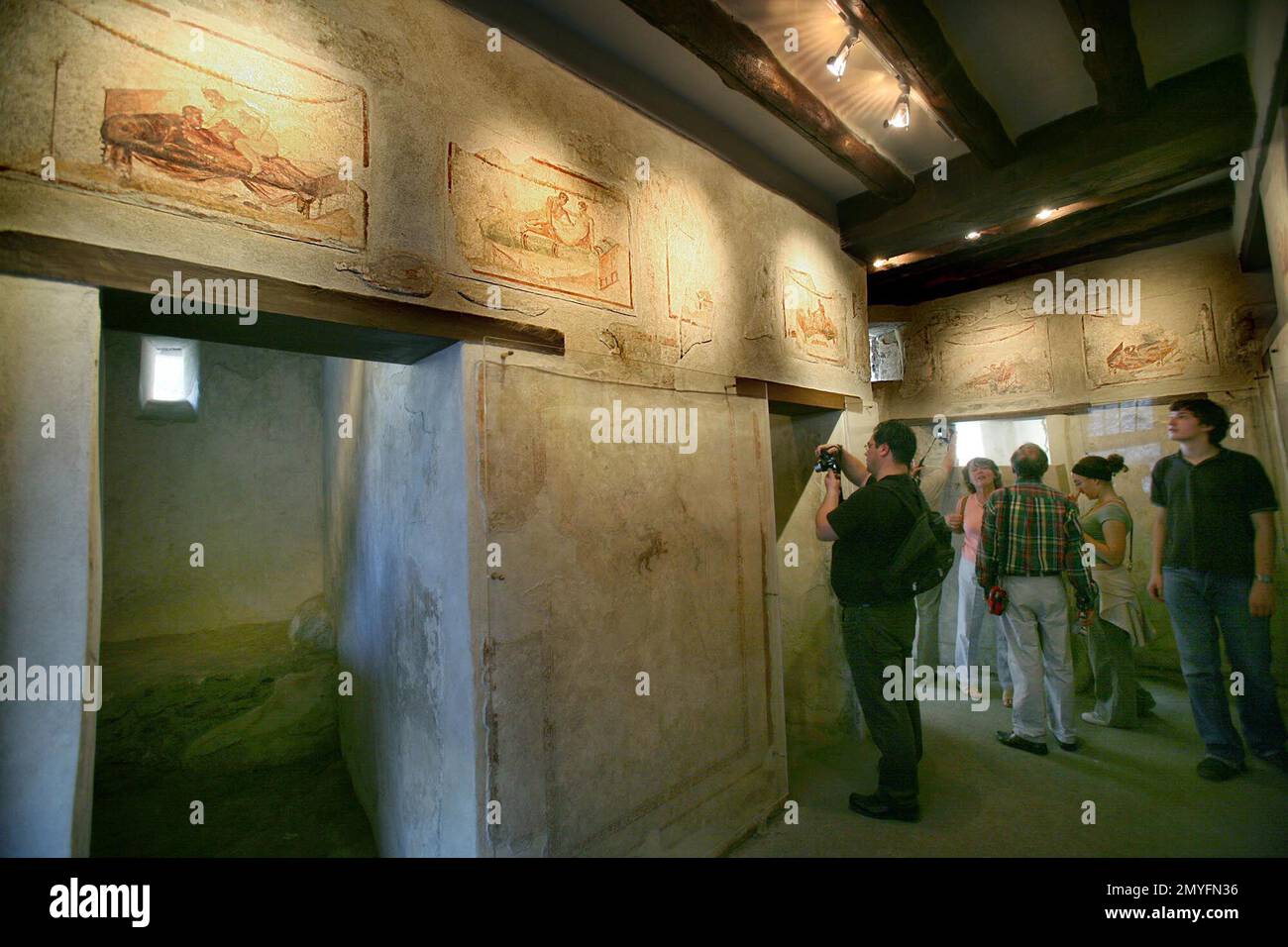 Visitors examine the "Lupanare", the newly restored brothel which ...