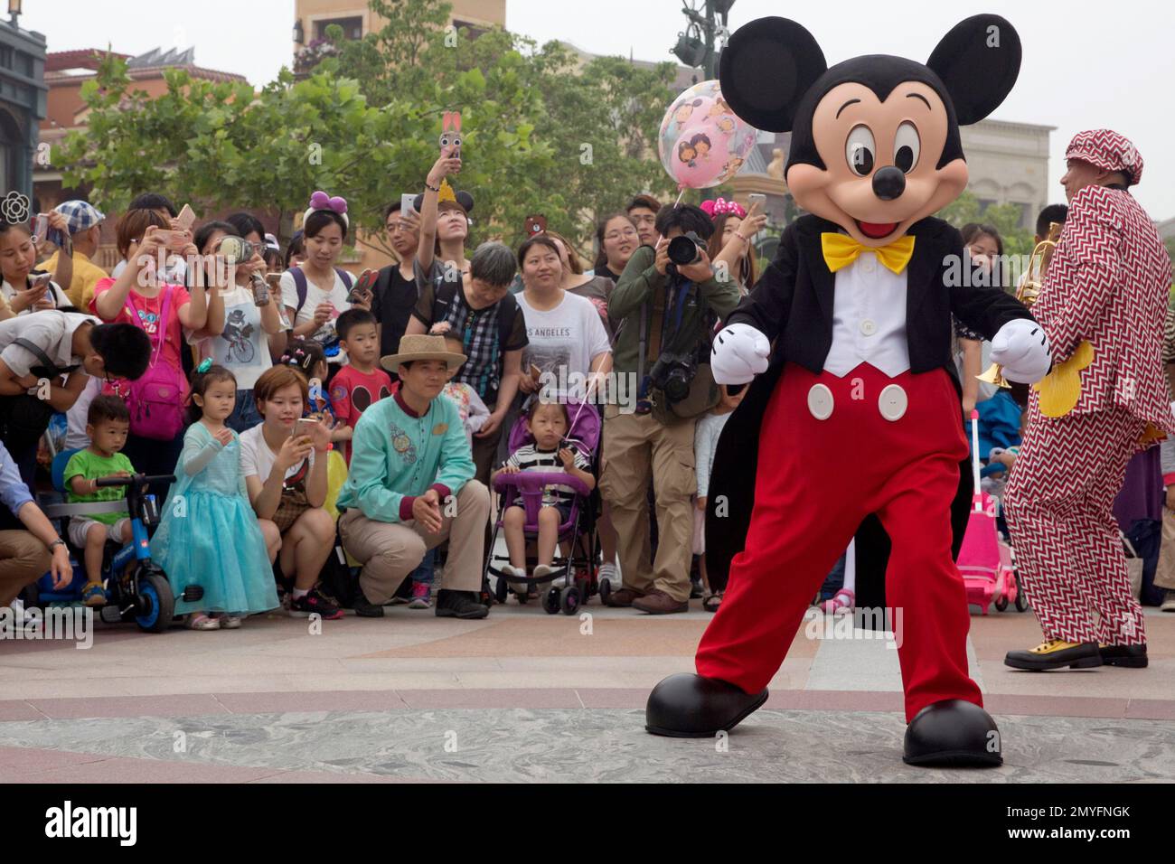 Mickey Mouse entertains visitors on the opening day of the Disney ...