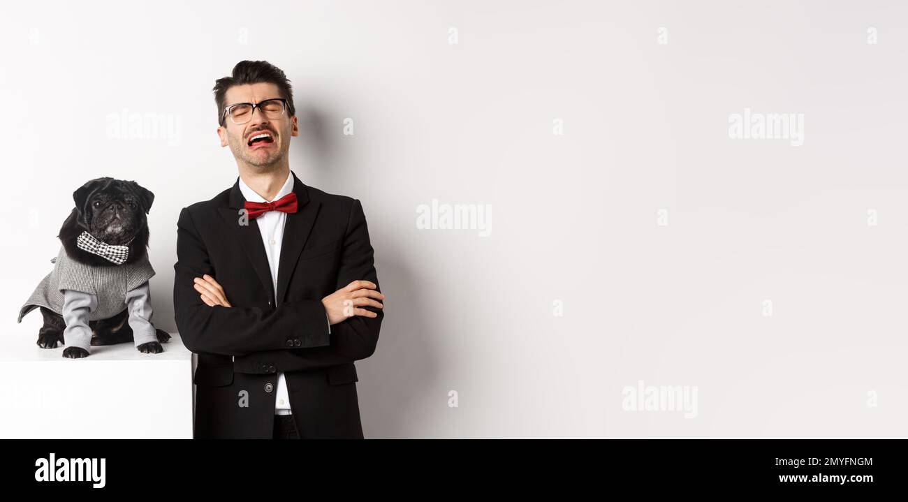 Animals, party and celebration concept. Sad dog owner crying, wearing ...