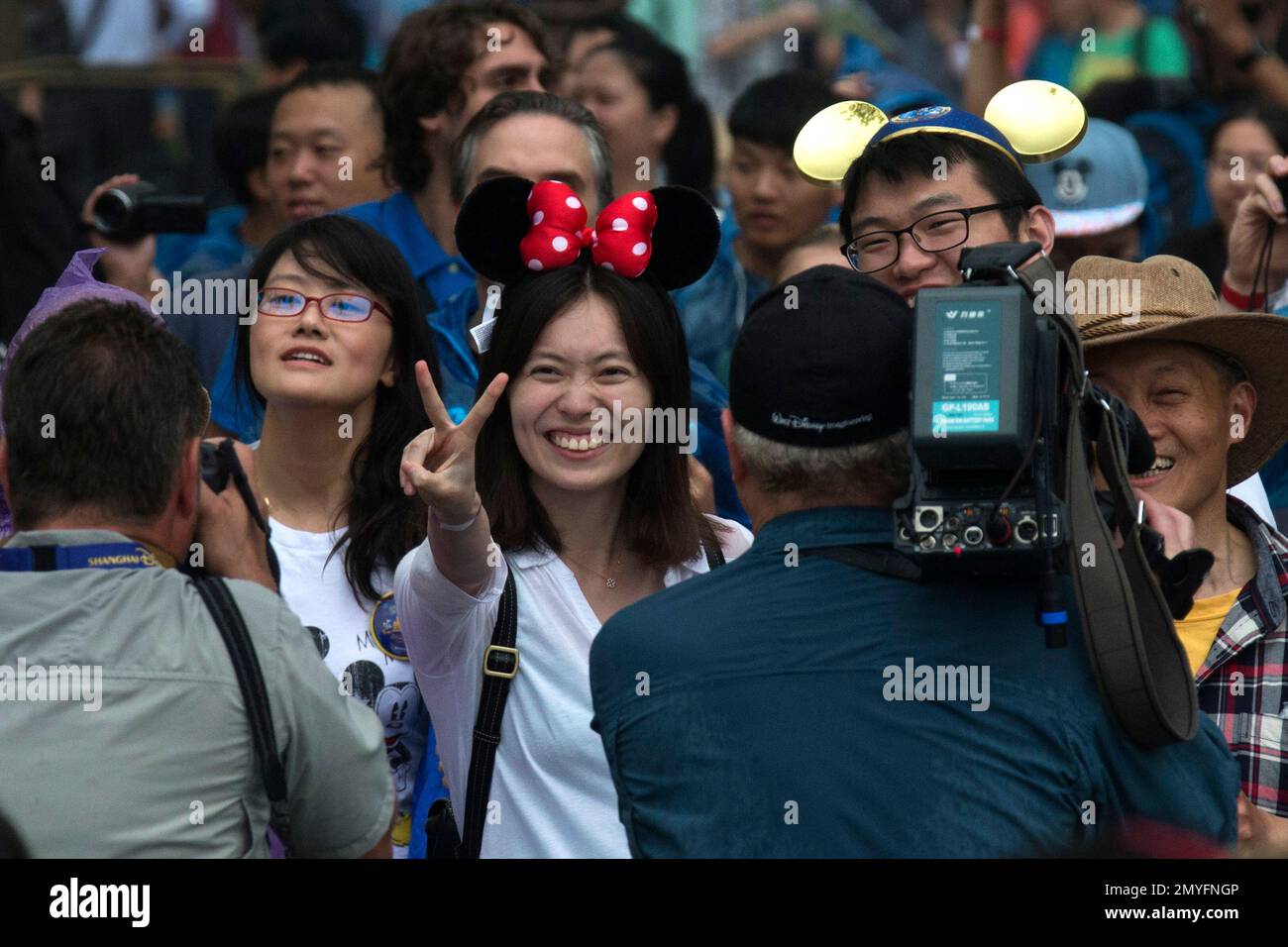Visitors react on opening day of the Disney Resort in Shanghai, China ...