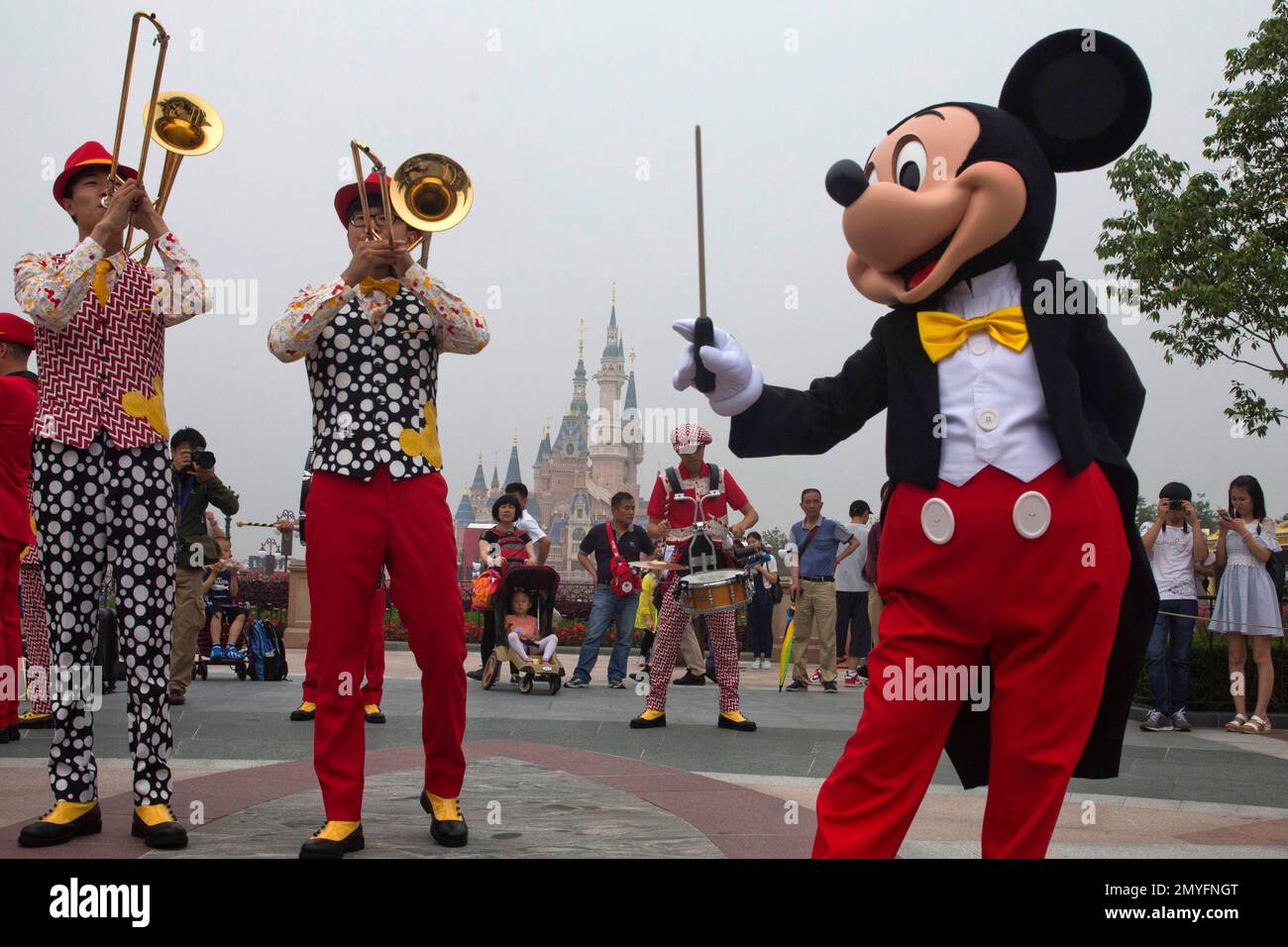 Mickey Mouse entertains visitors on the opening day of the Disney ...