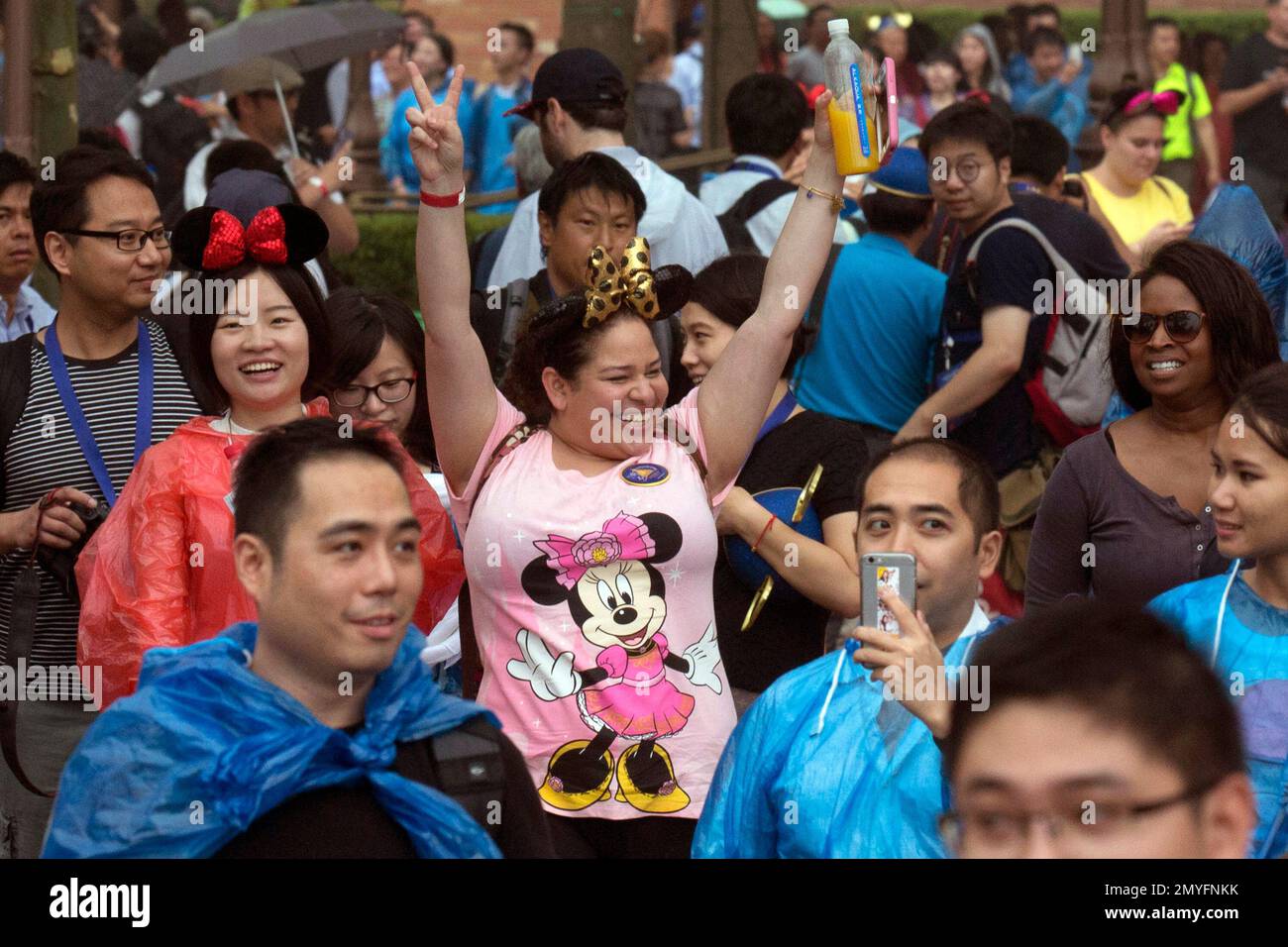 Visitors react on the opening day of the Disney Resort in Shanghai ...