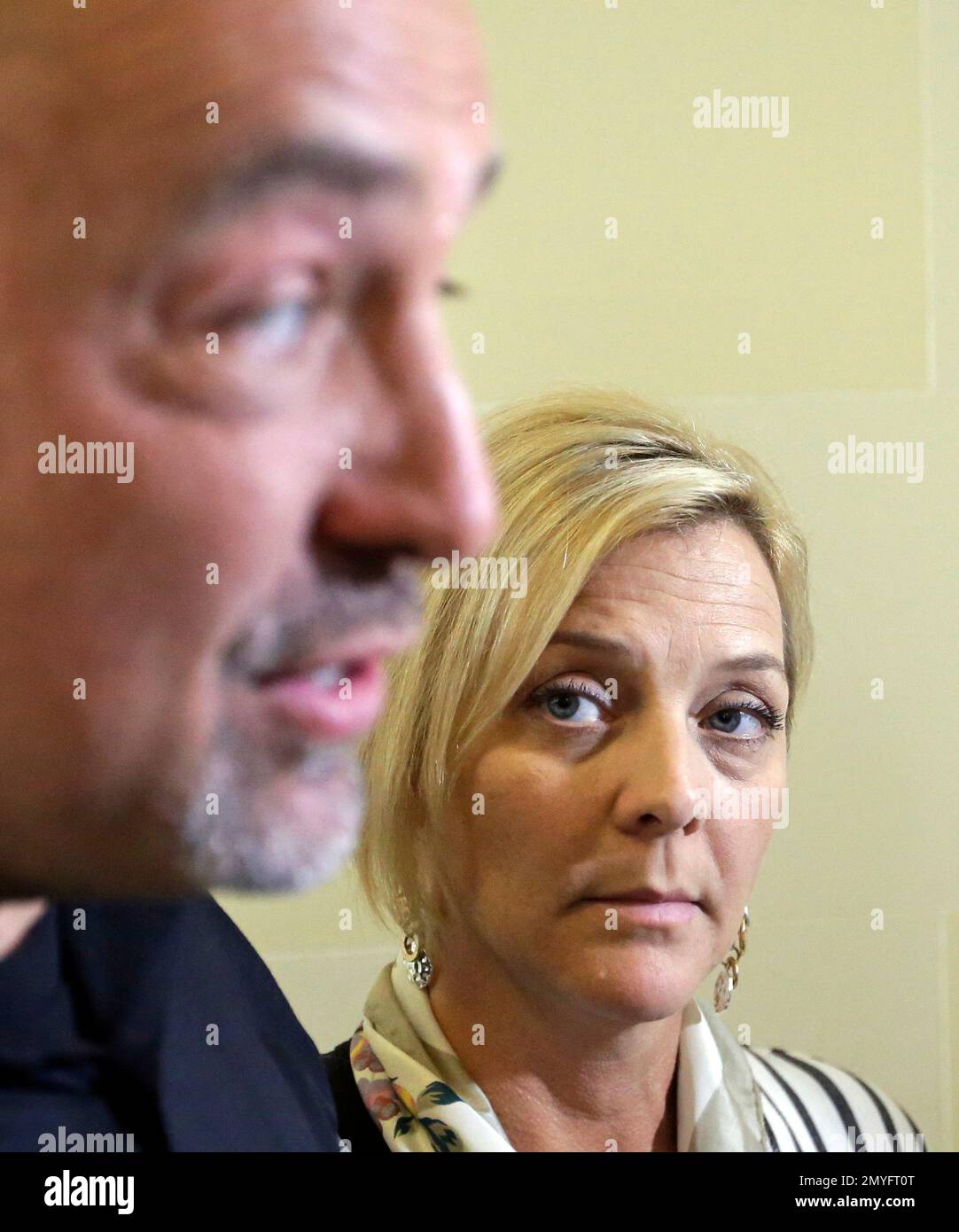 Linae Tiede Coats looks on as her husband Nathan Coats speaks with ...