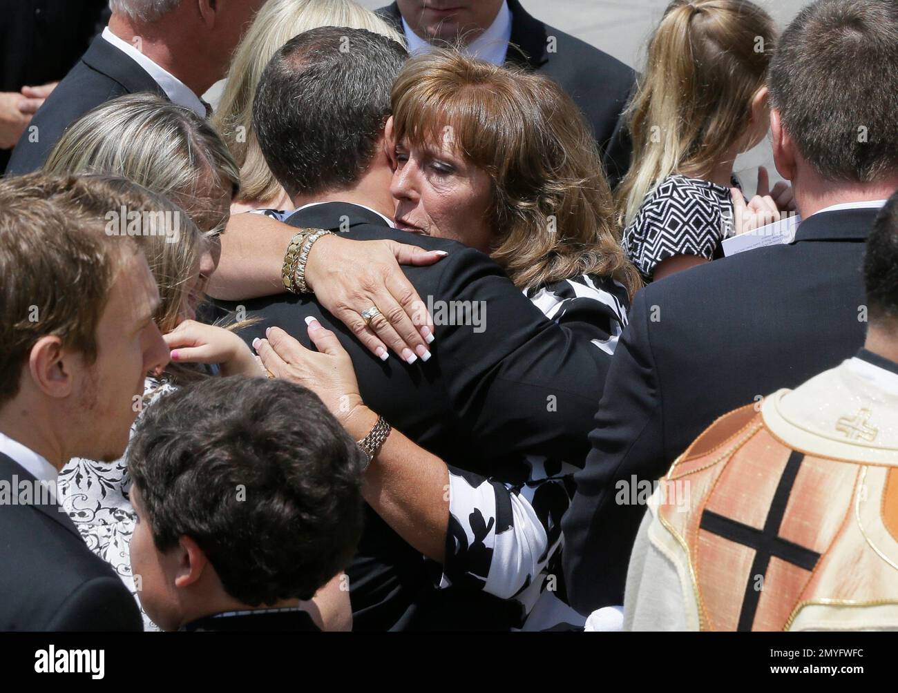 Cathy Howe embraces a family member after the funeral service for ...