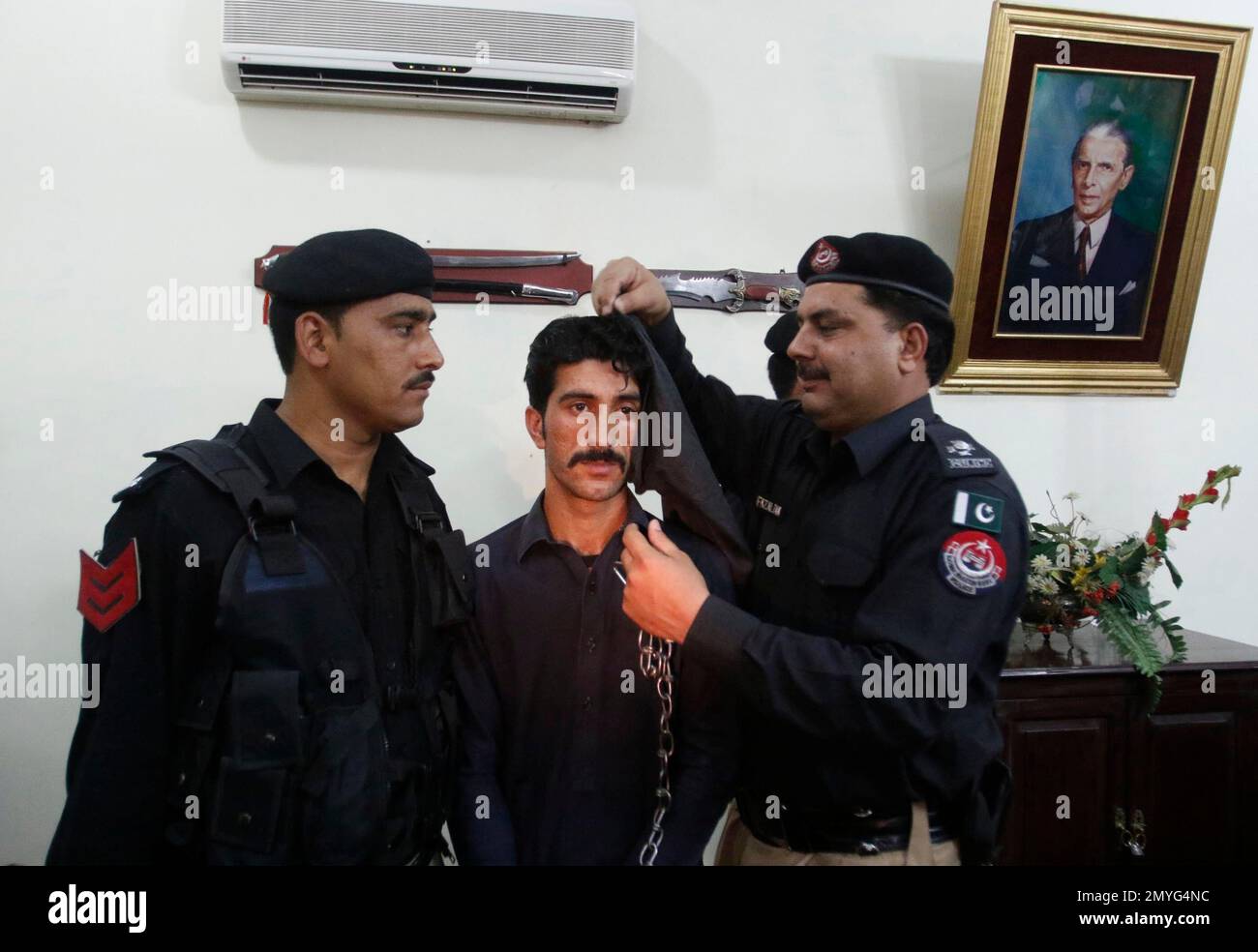 In this Sunday, May 29, 2016 photo, A Pakistani police officer covers ...