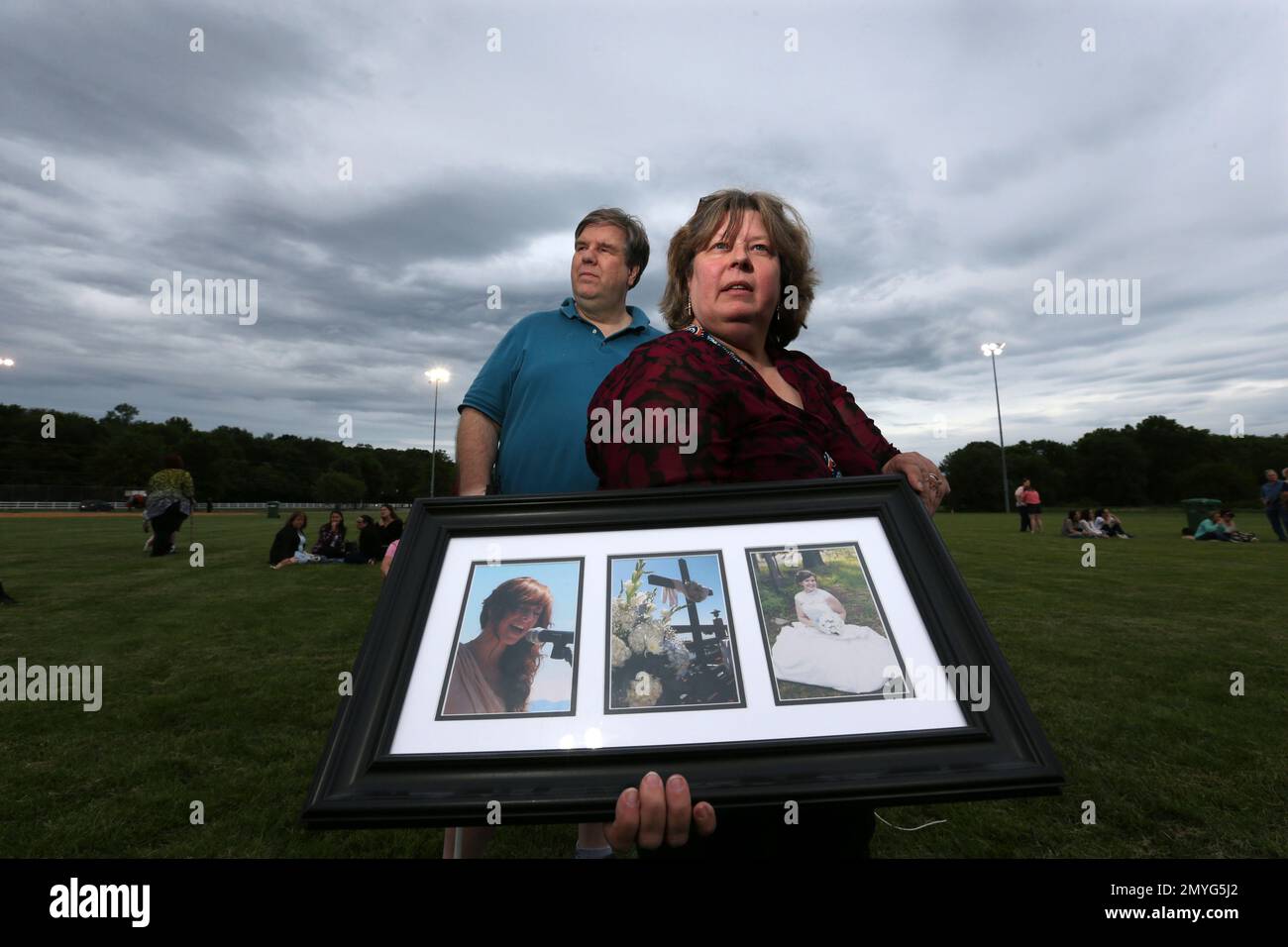 Debbie Hamilton stands with her husband Peter as she displays ...