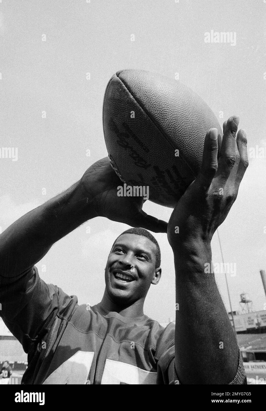 New York Giants end Homer Jones wraps his big hands around a football ...