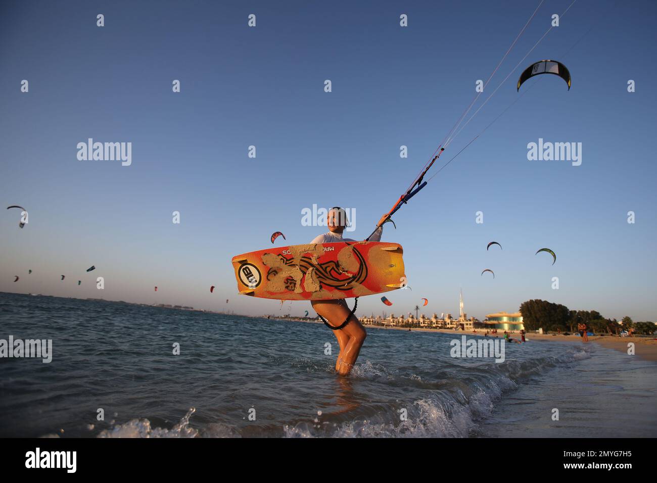A foreign woman goes kite surfing at Kite Beach in Dubai, United Arab ...