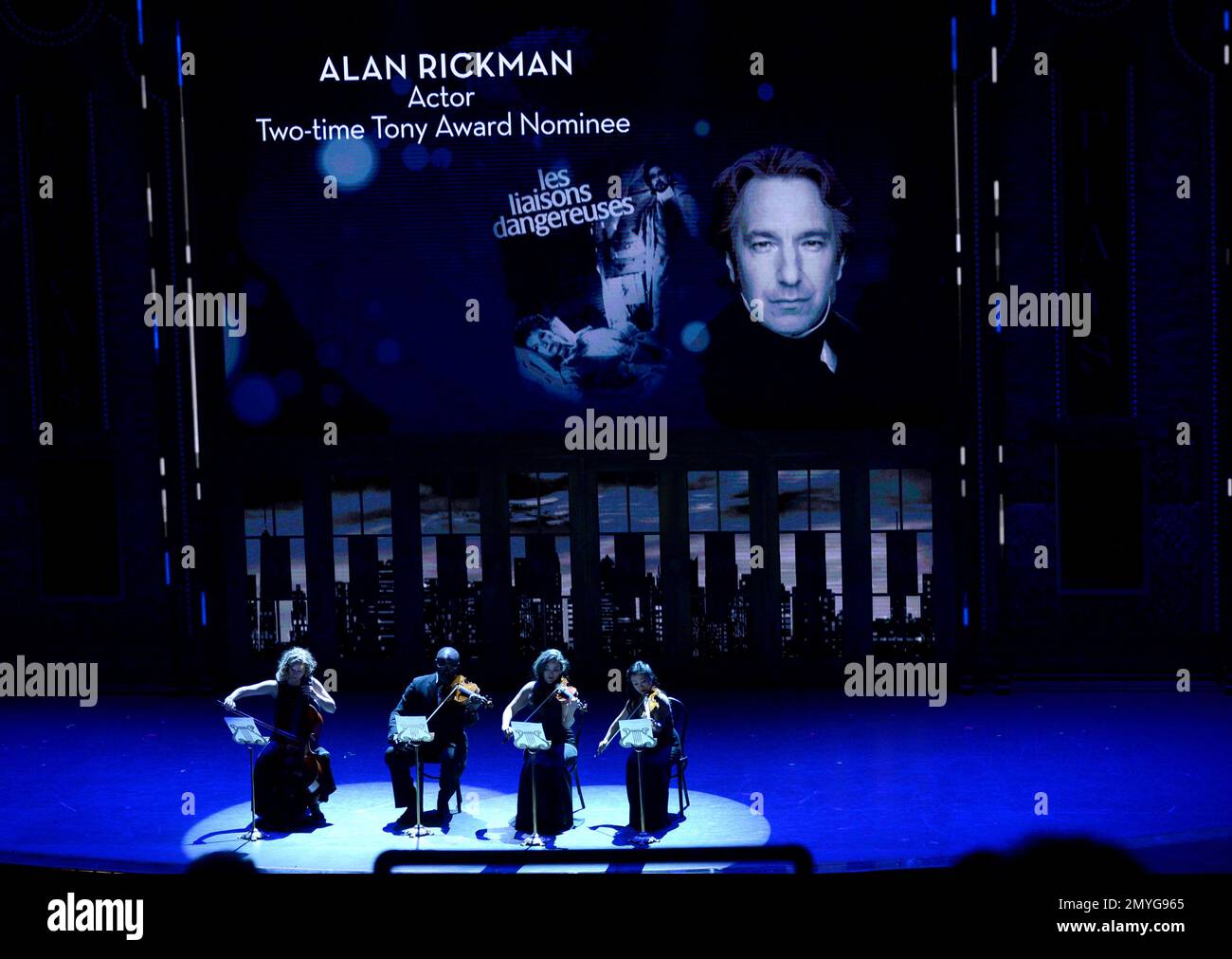An image of Alan Rickman is projected on a screen on stage as part of a ...