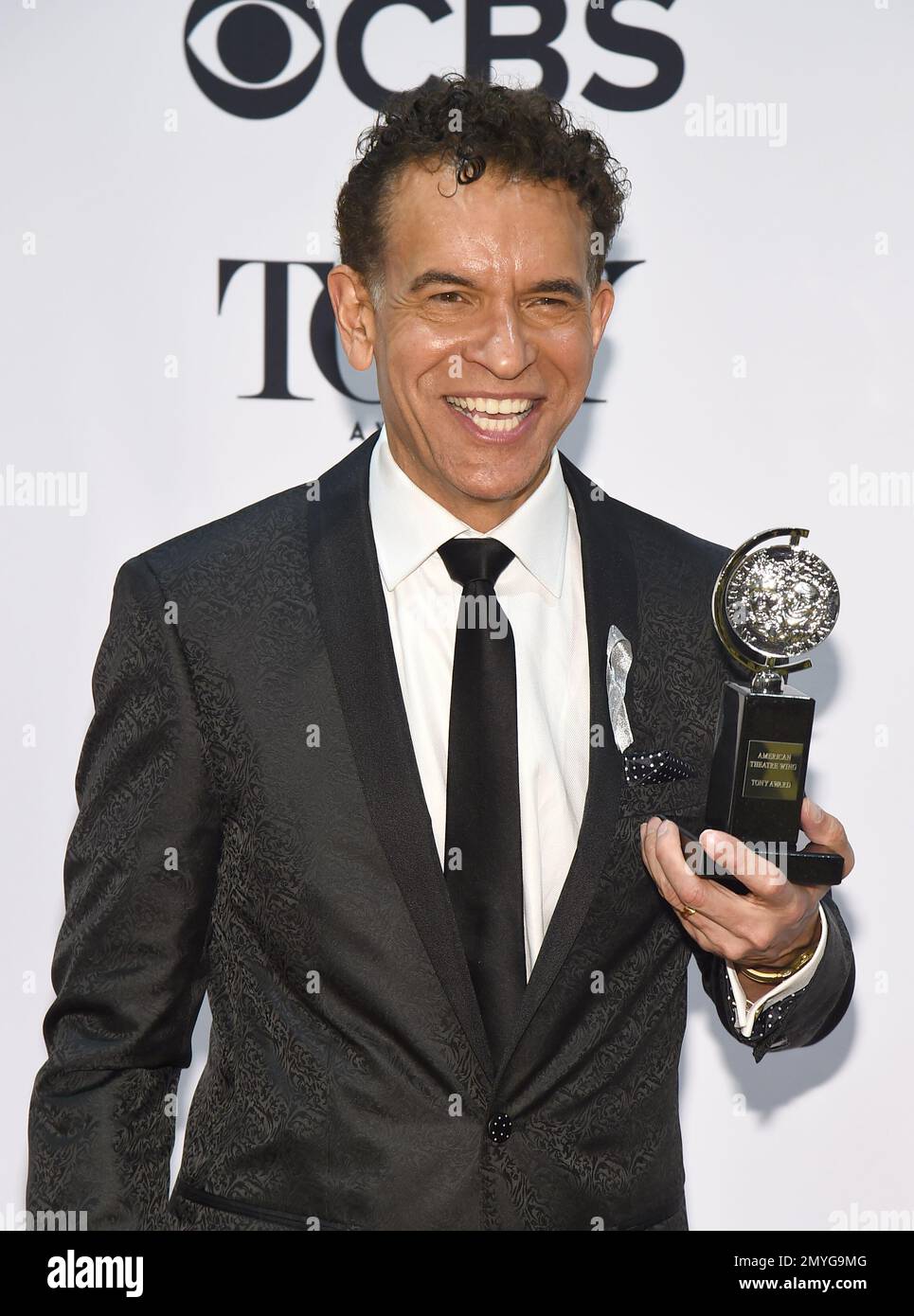Brian Stokes Mitchell poses in the press room with the Isabella ...