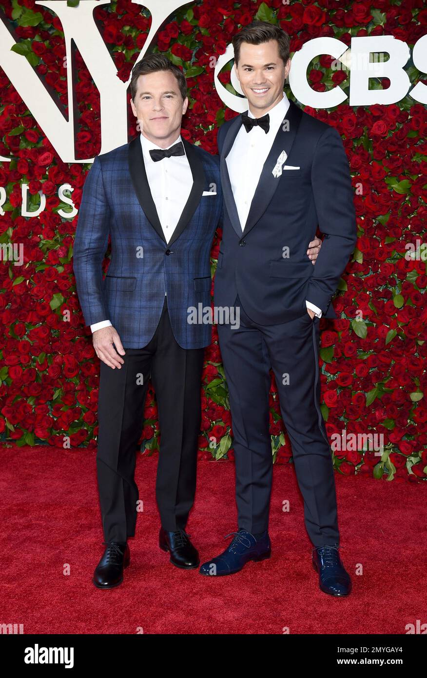 Michael Doyle, left, and Andrew Rannells, wearing a silver ribbon ...