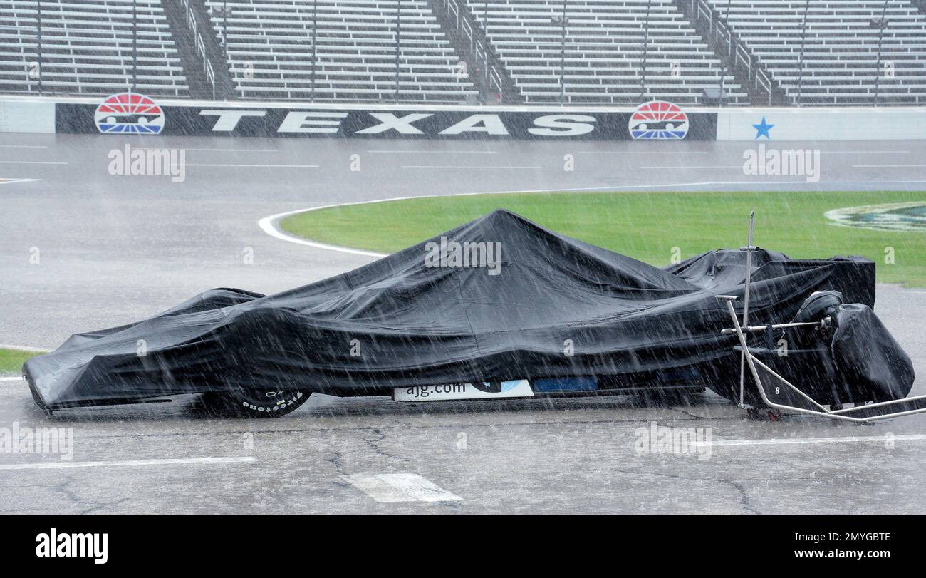 The race car of Max Chilton, from England, is covered by a tarp during ...
