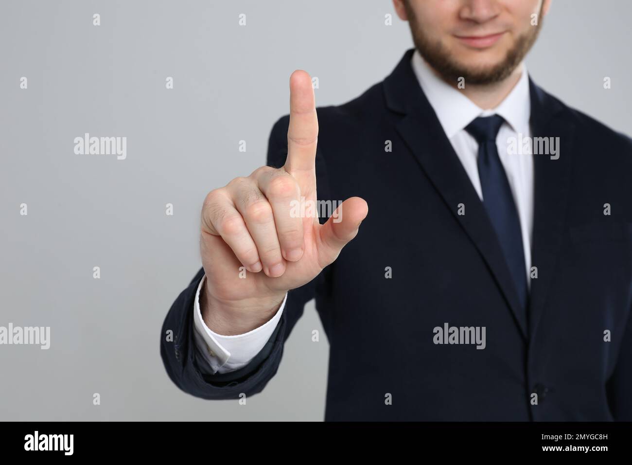Hand pointing against grey hi-res stock photography and images - Alamy