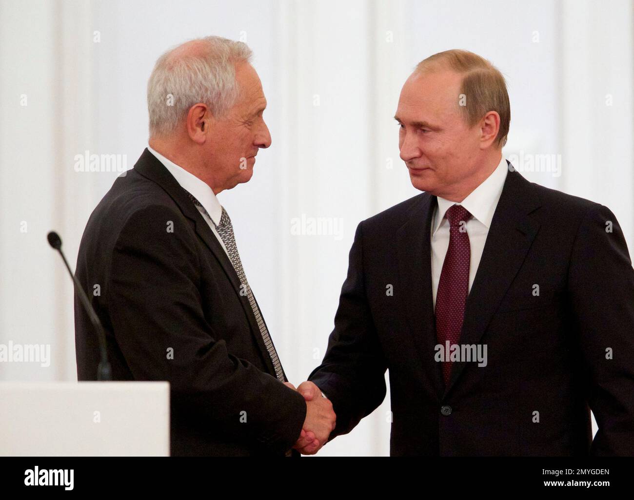 Russian President Vladimir Putin, right, shakes hands with Russian ...