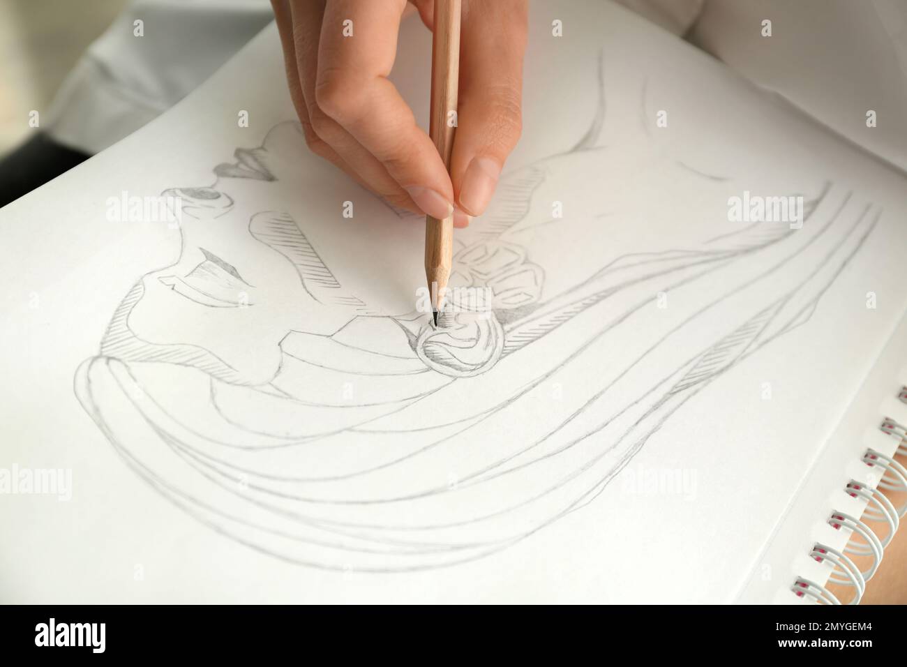 Woman drawing girl's portrait with pencil in notepad, closeup Stock ...