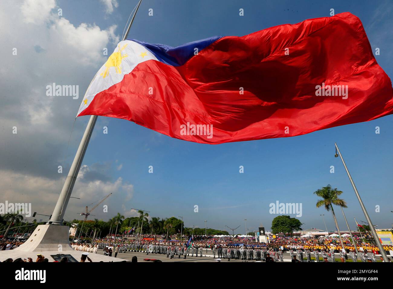 A giant Philippine flag is raised during a ceremony to celebrate the ...