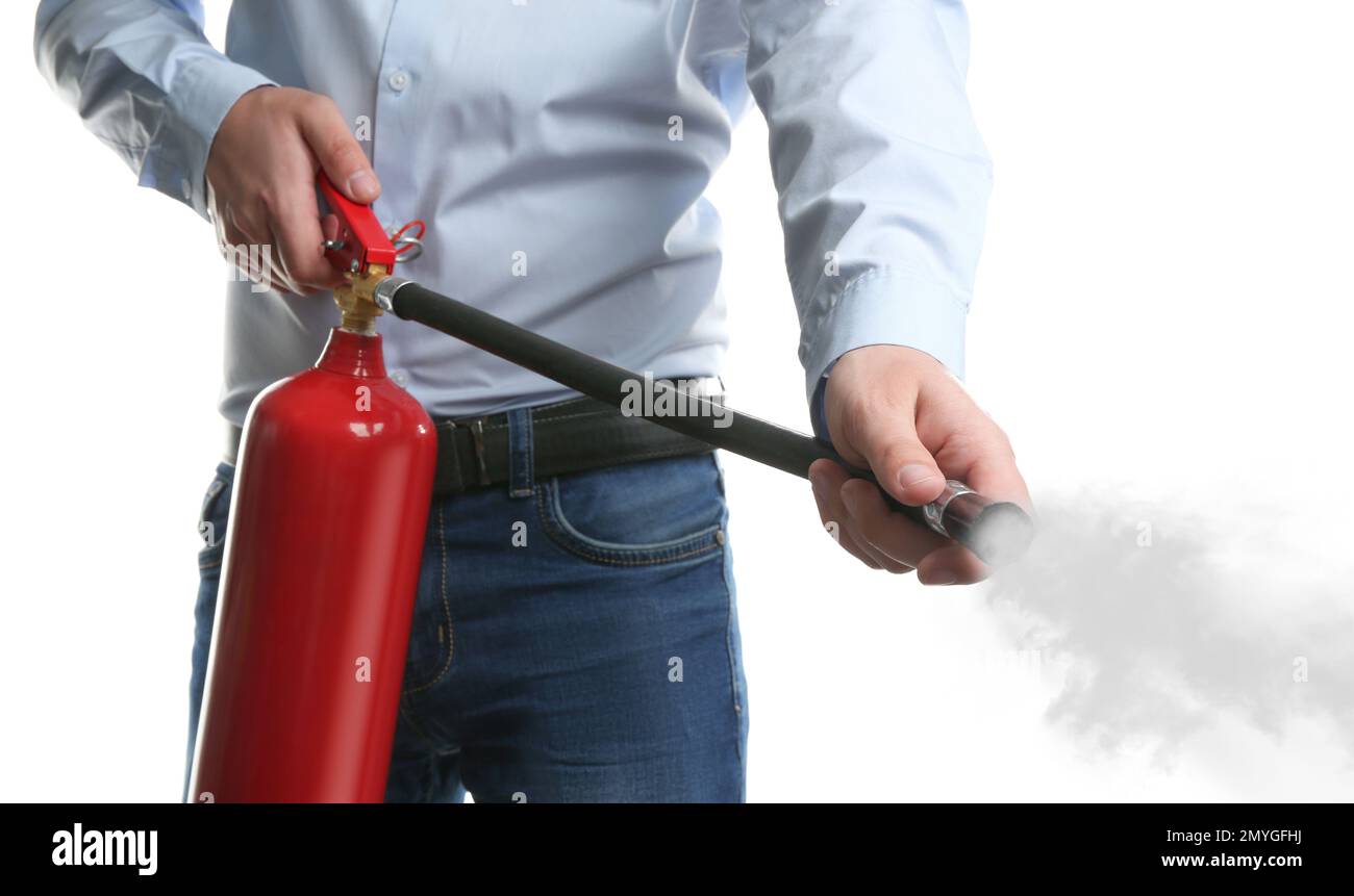 Man using fire extinguisher on white background, closeup Stock Photo ...