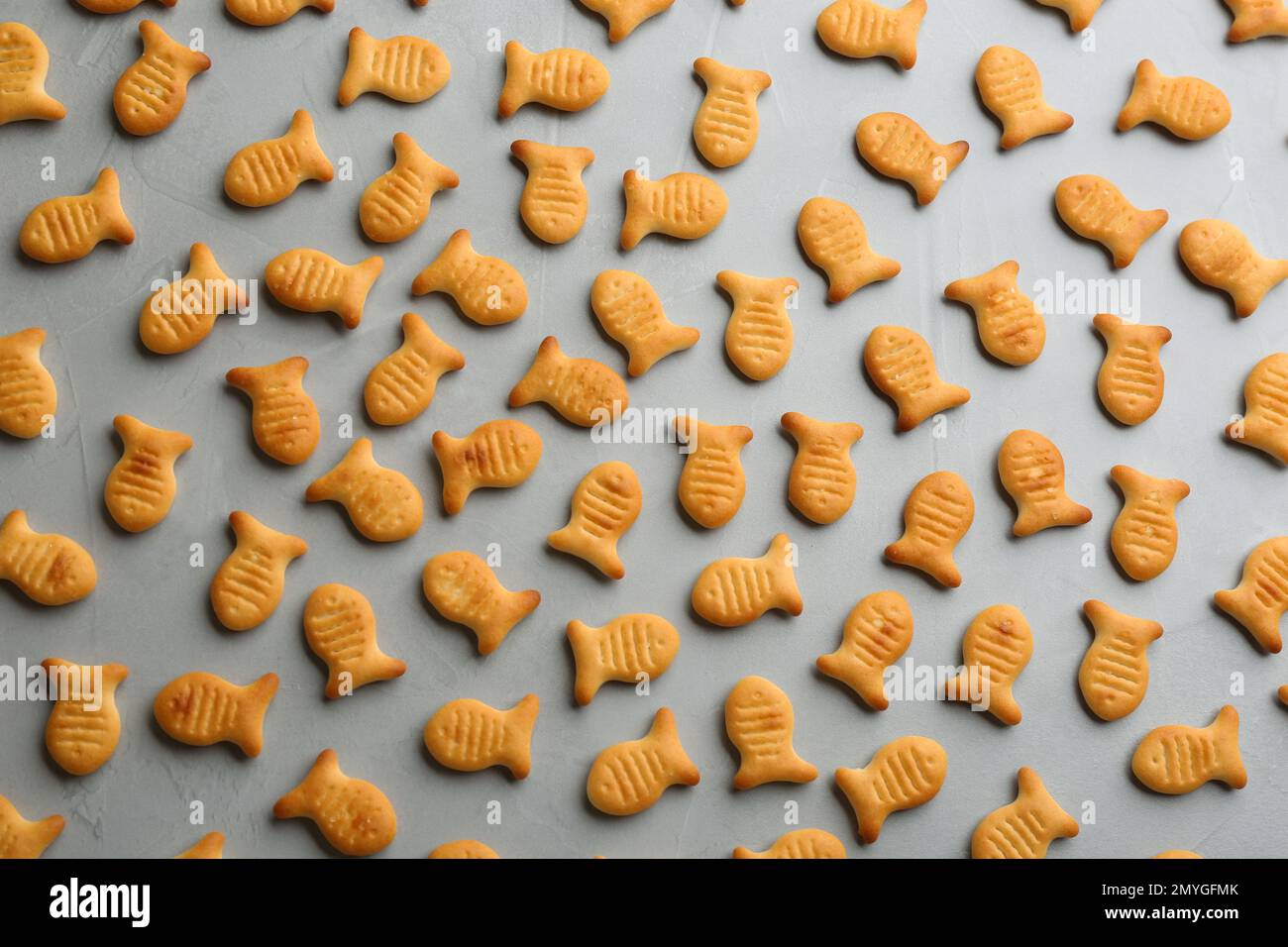 Delicious goldfish crackers on grey table, flat lay Stock Photo - Alamy
