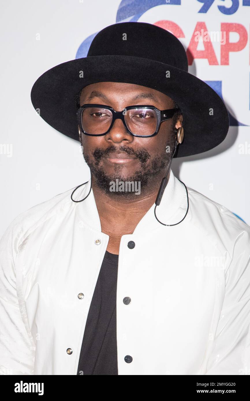 Singer Will.i.am poses for photographers before performing on stage at ...