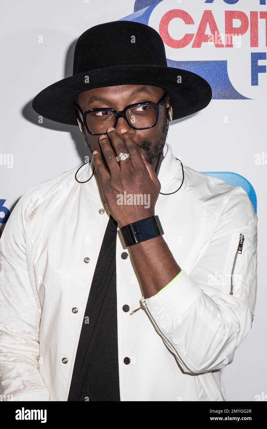 Singer Will.i.am poses for photographers before performing on stage at ...