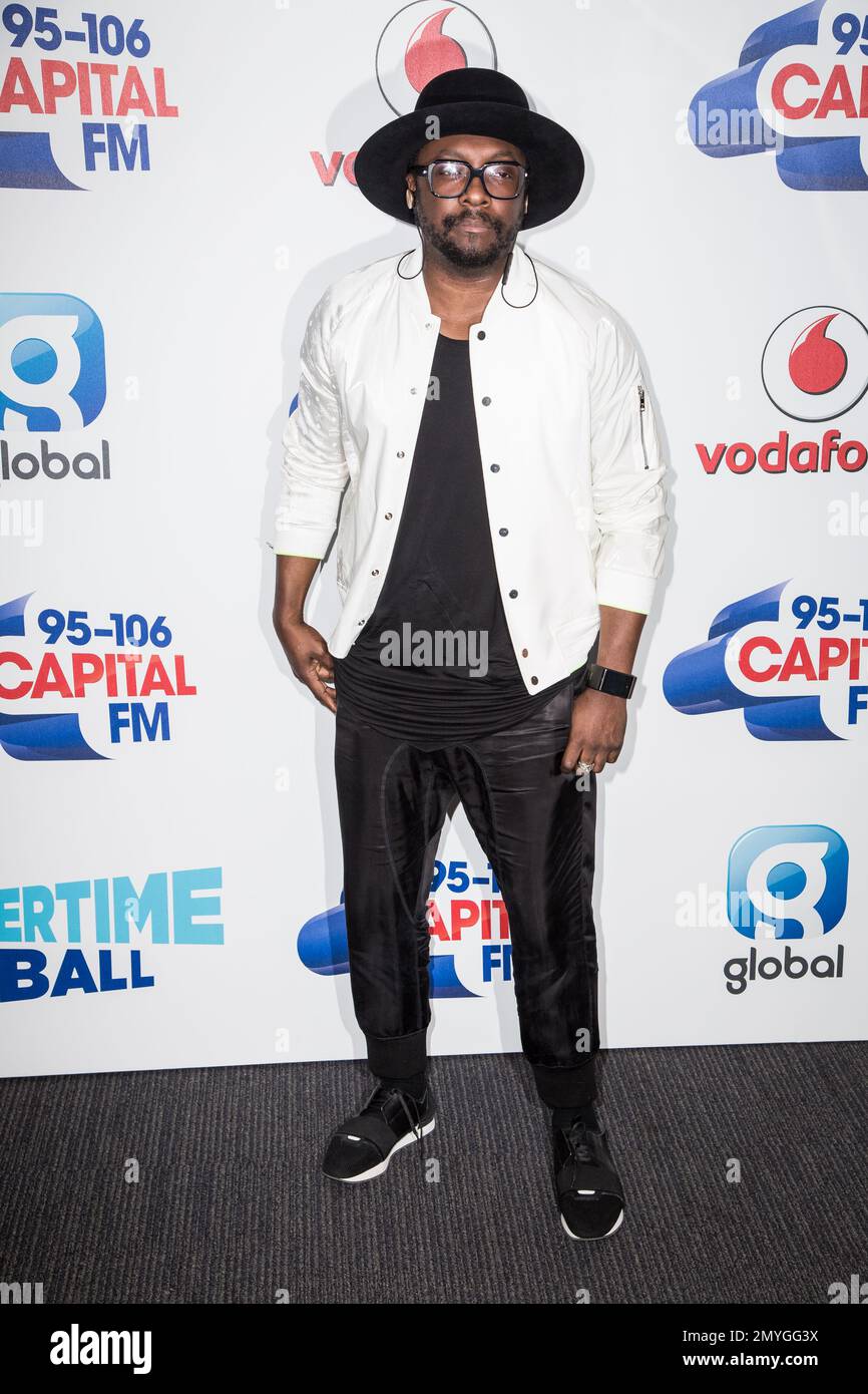 Singer Will.i.am poses for photographers before performing on stage at ...