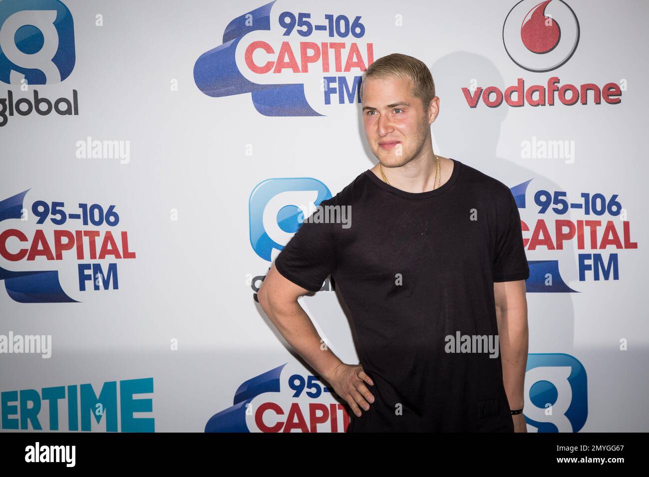 Singer Mike Posner poses for photographers before performing on stage ...