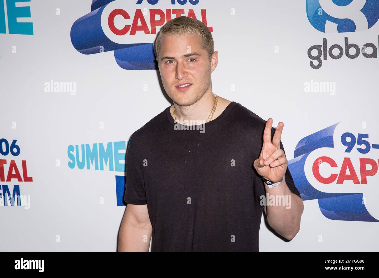 Singer Mike Posner poses for photographers before performing on stage ...