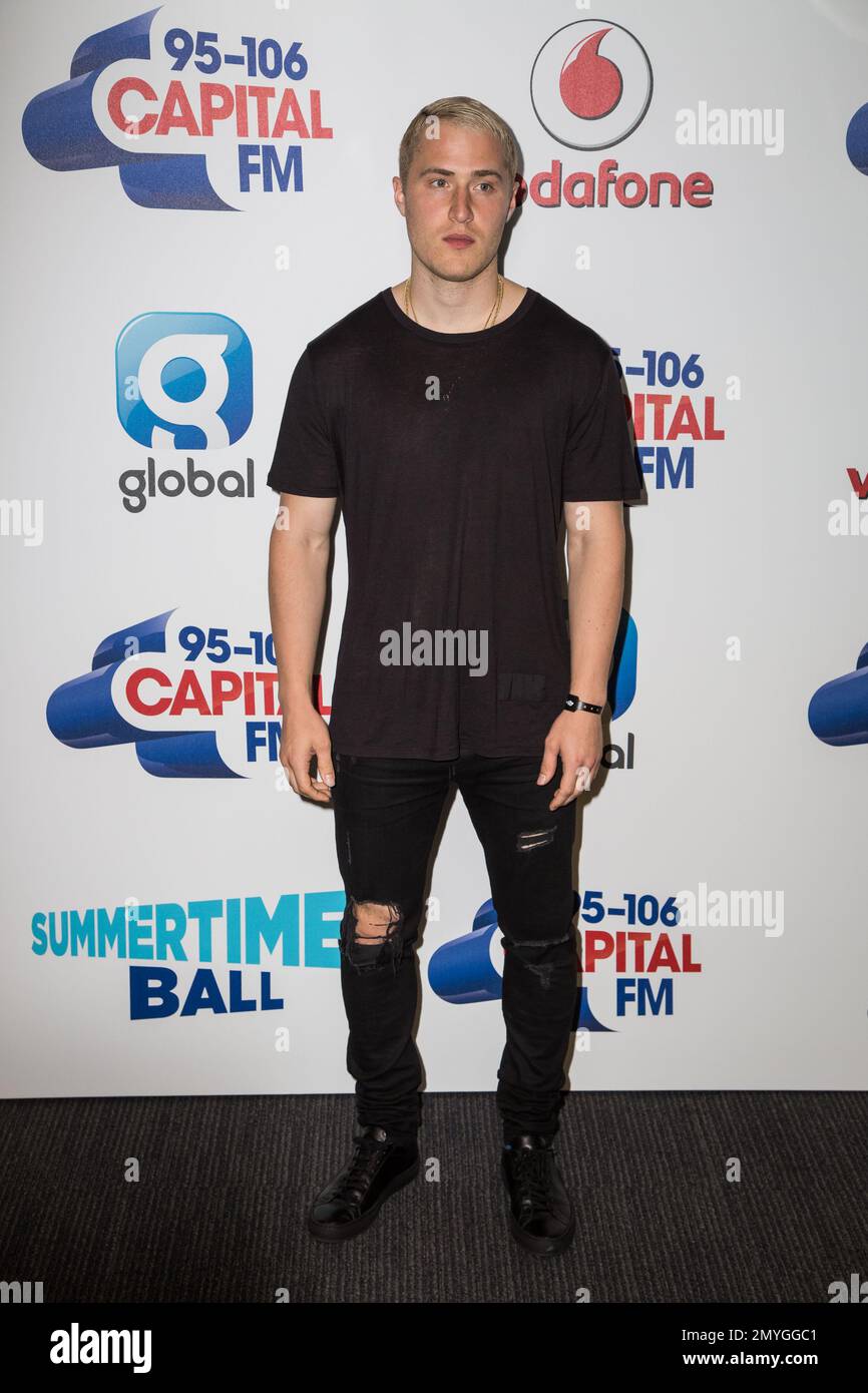 Singer Mike Posner poses for photographers before performing on stage ...