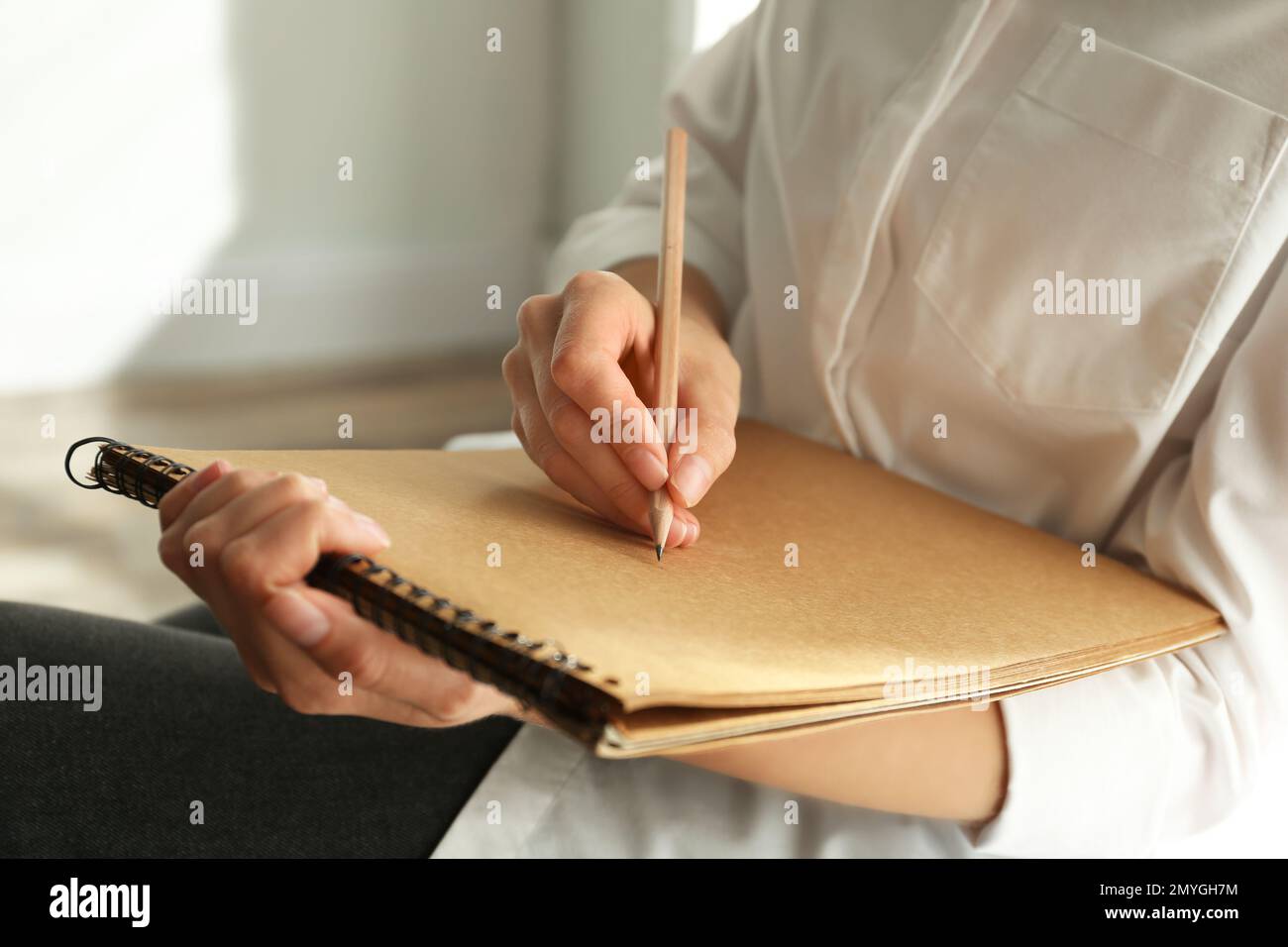 Woman drawing with pencil in notepad, closeup Stock Photo - Alamy