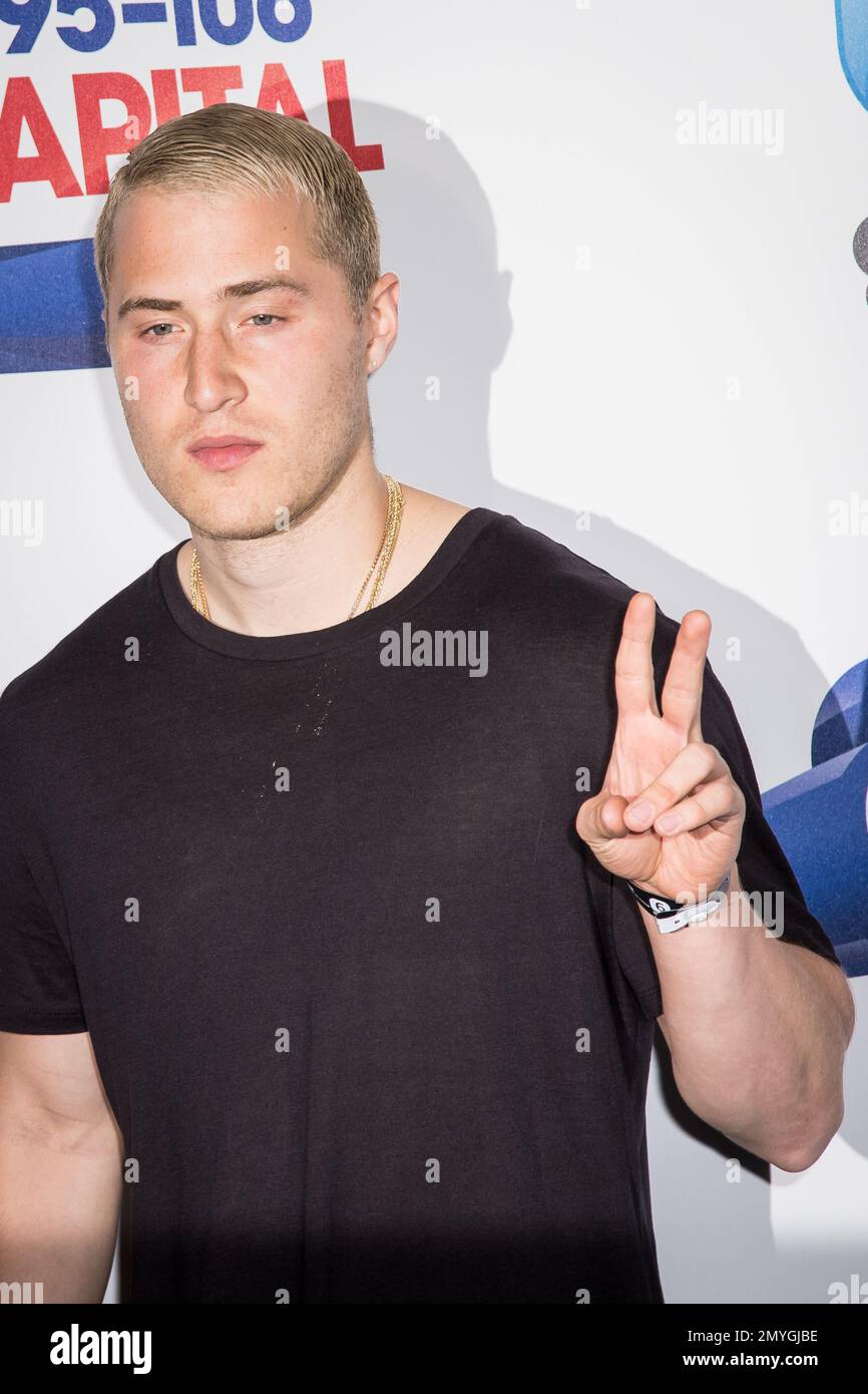 Singer Mike Posner poses for photographers before performing on stage ...