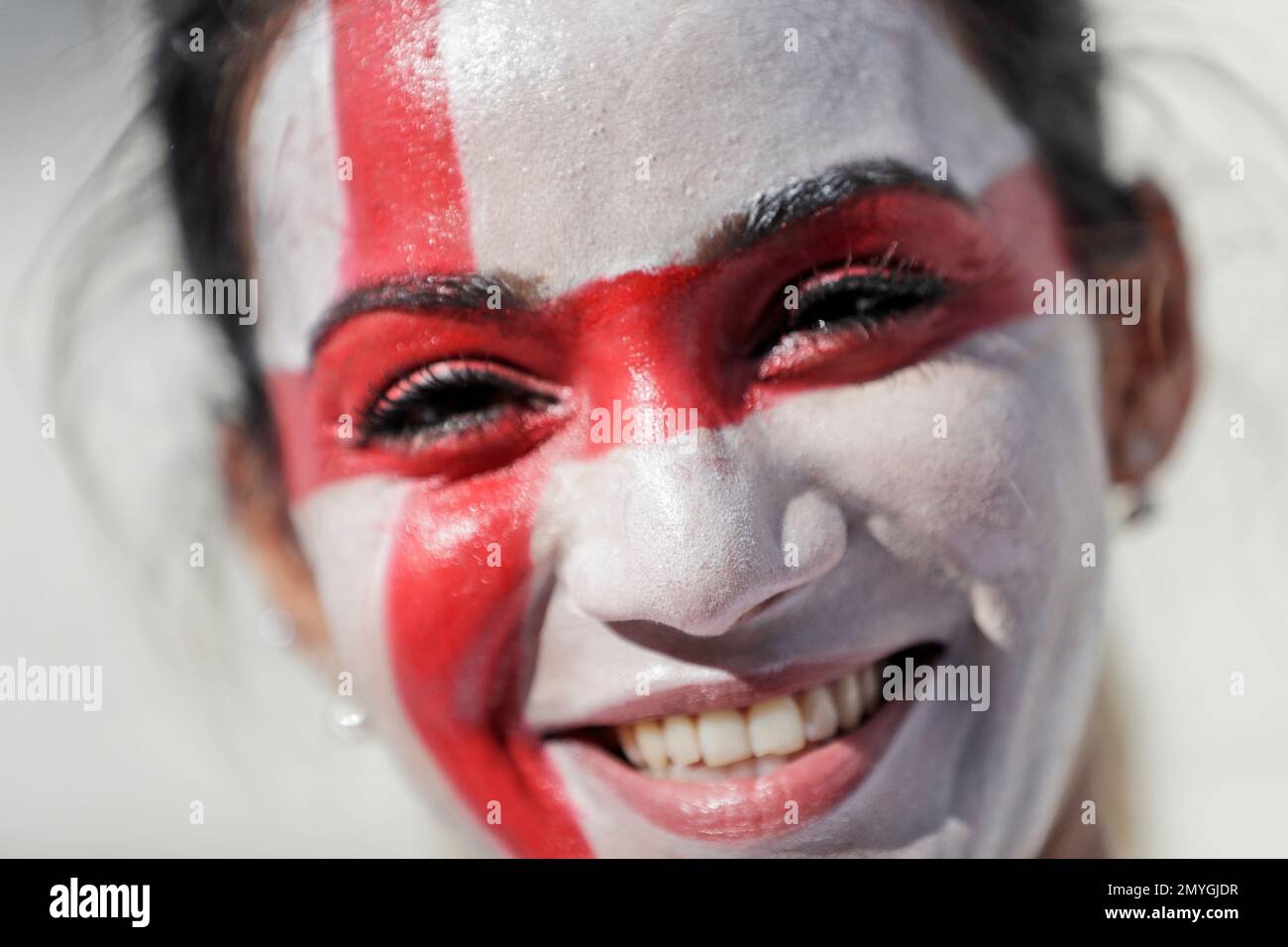 An English soccer fan smiles as she enters the Velodrome stadium ahead ...