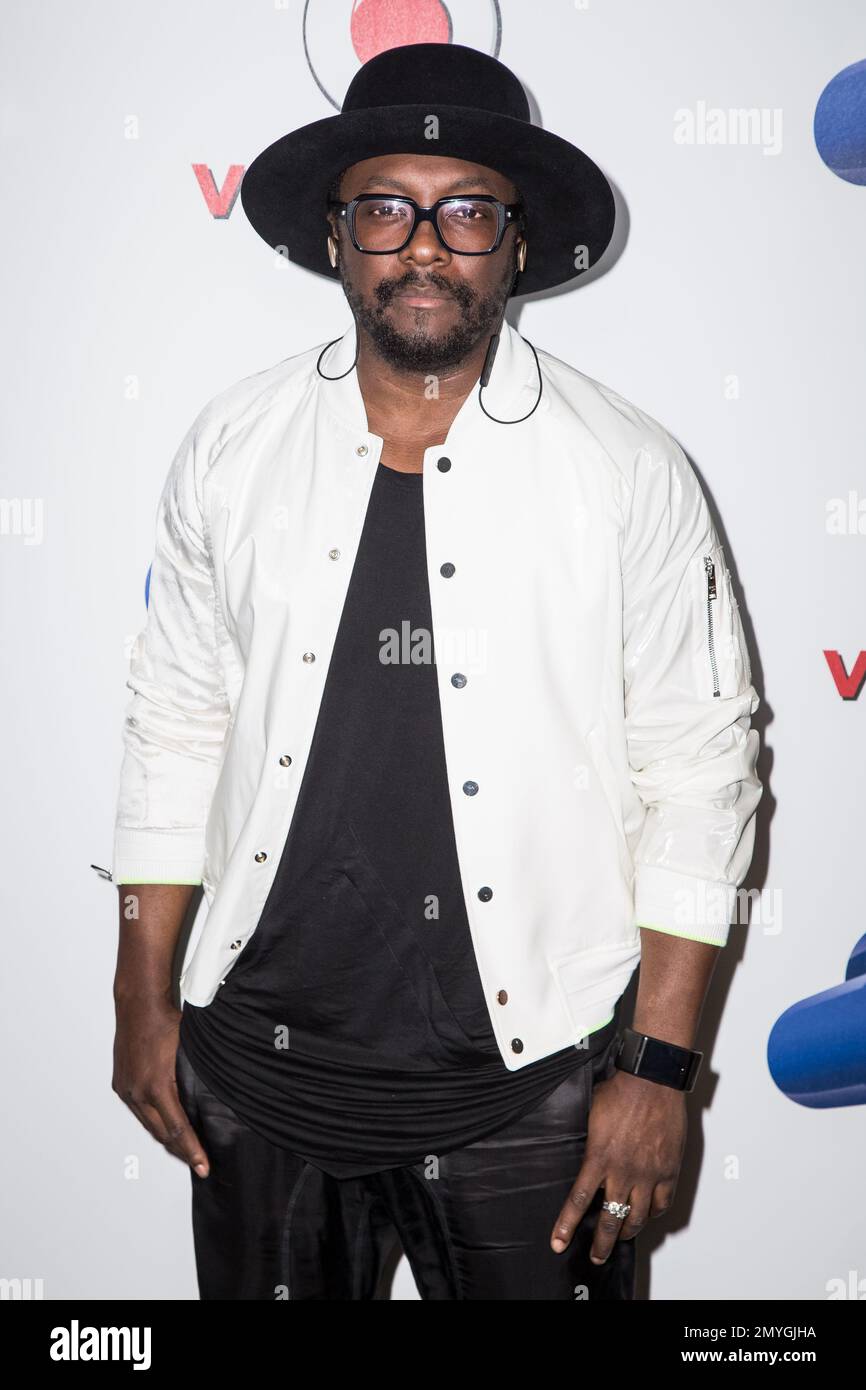 Singer Will.i.am poses for photographers before performing on stage at ...