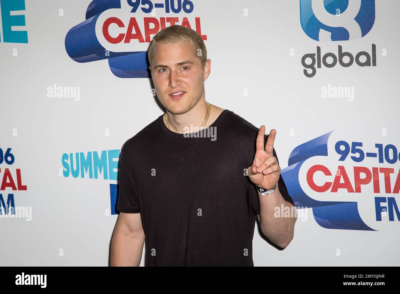 Singer Mike Posner poses for photographers before performing on stage ...